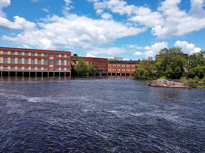 Historic brick buildings reflect in the Wisconsin River, their sturdy foundations mirroring the resilient character of this paper mill town.