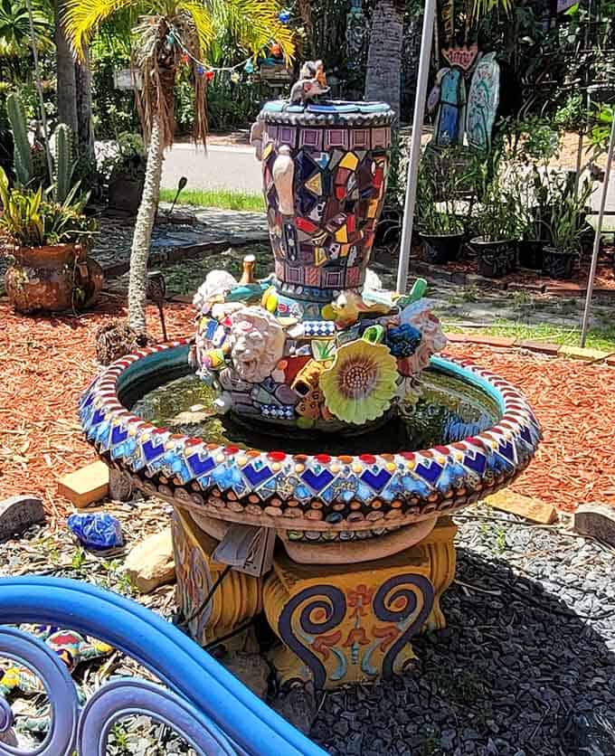 This fountain combines mosaics, color, and water into a centerpiece that anchors the yard's joyful chaos perfectly.