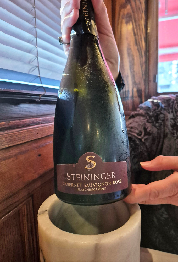 A bottle of Steininger Ros&eacute; Sekt &ndash; evidence that bubbles elevate any dining experience, especially in a vintage train car in Vermont.