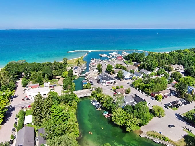 From above, Leland reveals its perfect positioning – nestled between lakes, surrounded by green, and blessed with that impossible blue water.