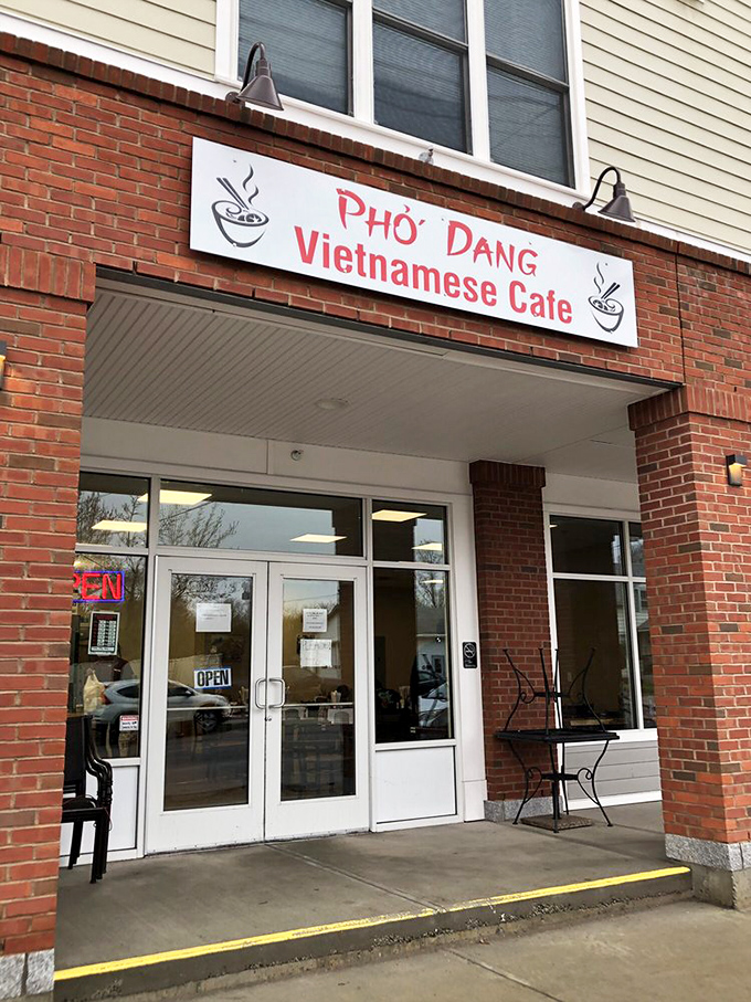 The brick-fronted entrance with its simple red sign gives little hint of the extraordinary culinary journey waiting inside.
