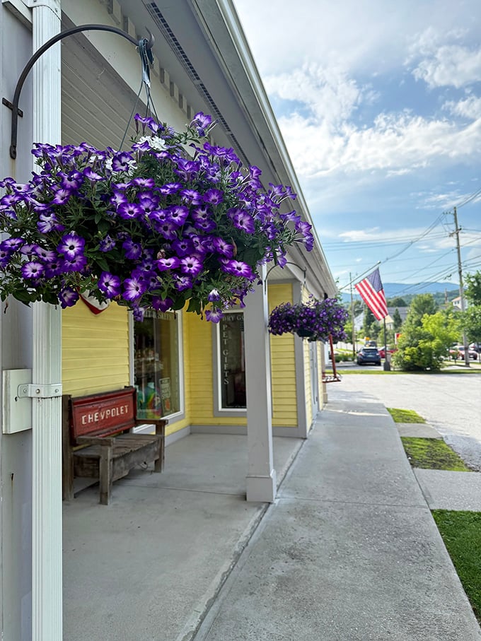 Hanging flower baskets and a welcoming porch invite visitors to slow down and savor the Vermont experience.