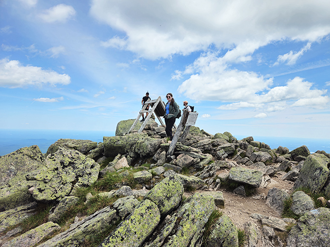 Triumphant hikers atop Katahdin's summit, where oxygen is optional but views are mandatory. The human equivalent of "I climbed all this way and all I got was this absolutely life-changing panorama."
