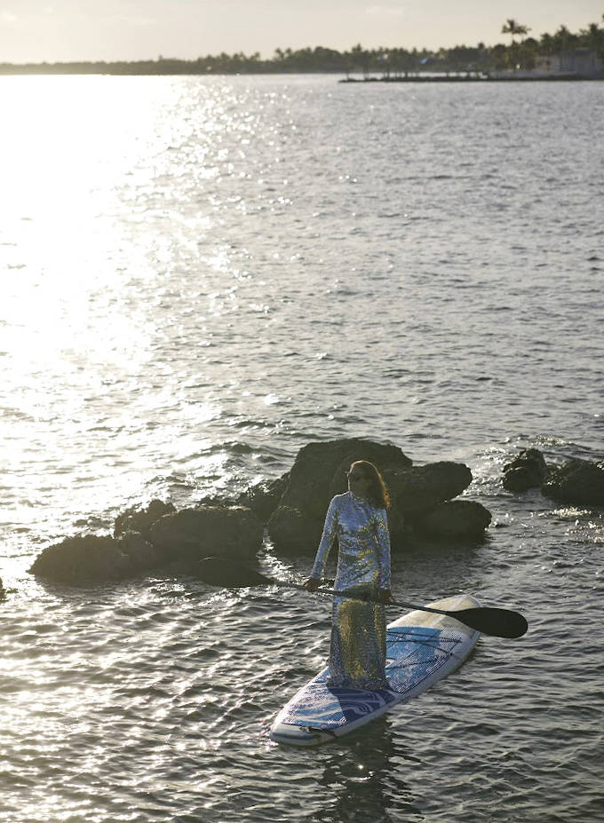 Sunset paddler: Gliding across liquid gold as day surrenders to evening, creating ripples that catch the last light like scattered diamonds.