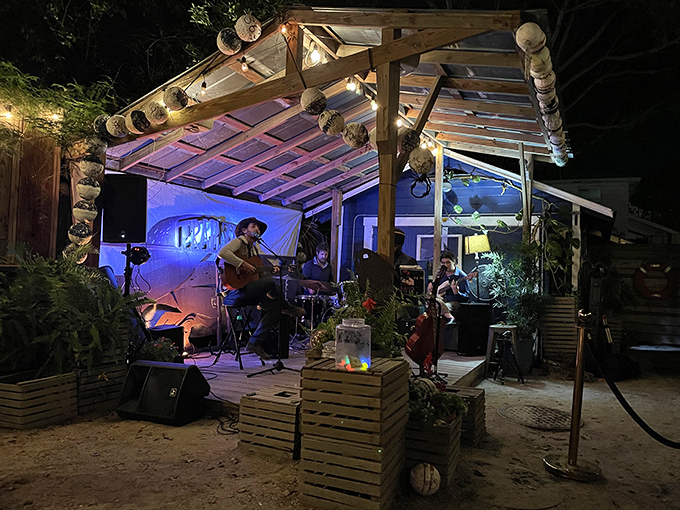 As night falls, the outdoor space transforms into a twinkling concert venue where local musicians provide the perfect soundtrack to your seafood feast.