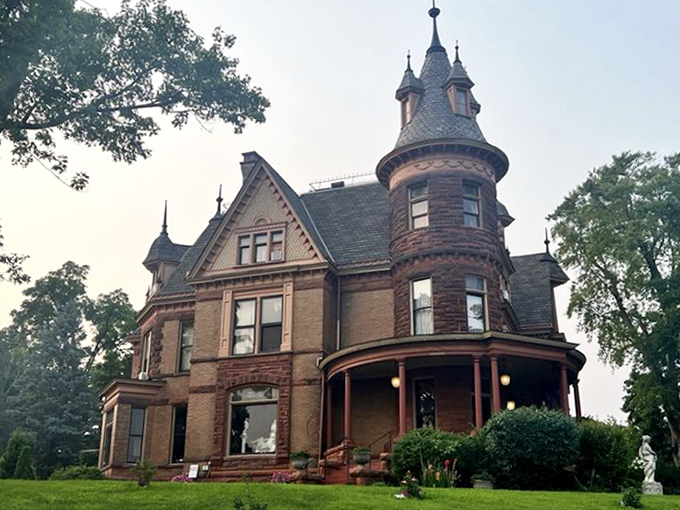 The castle's exterior view showcases its architectural splendor &ndash; Victorian grandeur that somehow looks right at home in the Michigan landscape.