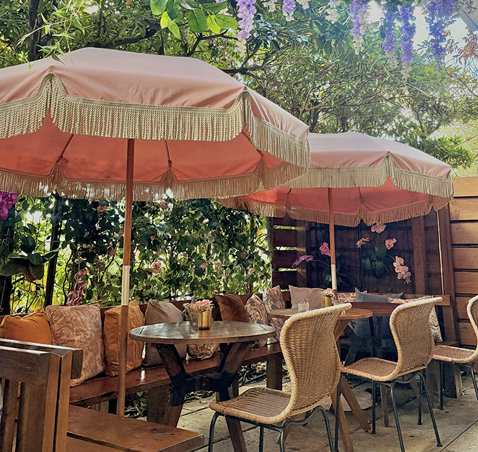 Outdoor seating that feels like you've stumbled into a secret garden party. Those wicker chairs have witnessed more delightful gossip than any therapist's couch.