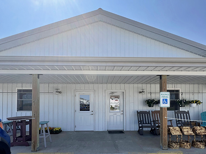 The welcoming porch, complete with rocking chairs, invites visitors to slow down and savor the simple pleasures of country life.