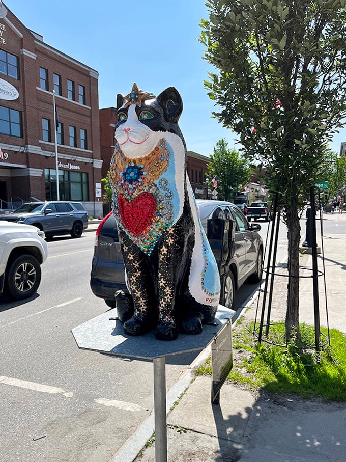 This decorative cat statue stands guard outside, welcoming visitors with colorful mosaic details and a heart-warming design.
