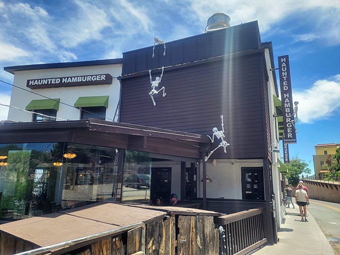 Climbing skeletons adorn the restaurant's exterior, setting the playfully spooky tone before you even step inside for your burger adventure.