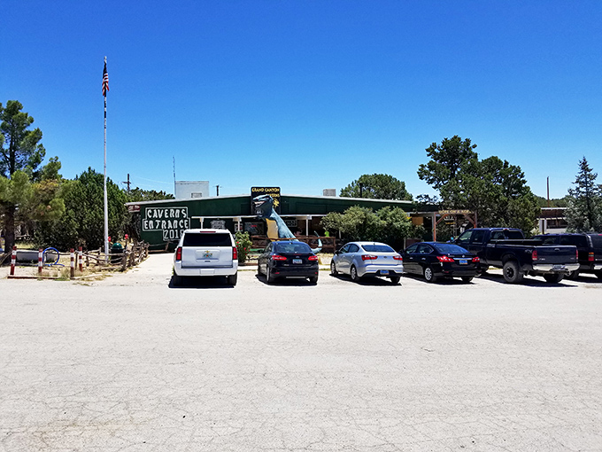 Another dinosaur stands guard at the cavern entrance, a playful nod to the ancient history preserved below.