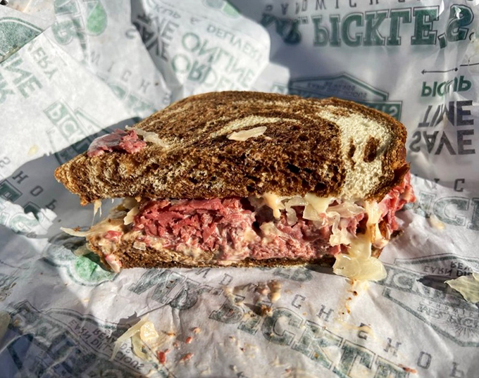 The Reuben &ndash; a masterclass in sandwich architecture with perfectly balanced layers of pastrami, Swiss, and sauerkraut on marble rye.