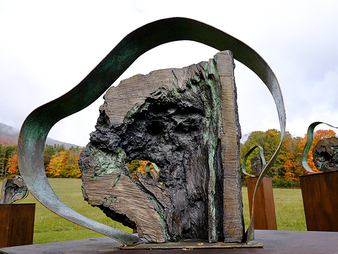 Nature and art merge in this sculptural piece, where metal curves embrace natural wood in a harmonious outdoor installation.
