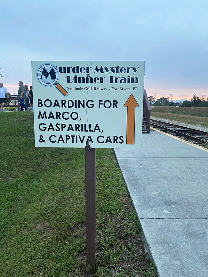 A directional sign points the way to adventure, guiding guests to their cars for an evening of culinary detective work on the rails.