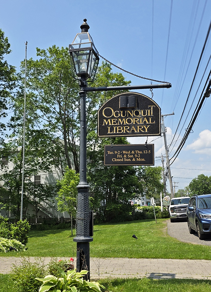 The classic hanging sign announces your arrival at a literary landmark, with convenient hours posted for planning your next reading adventure.