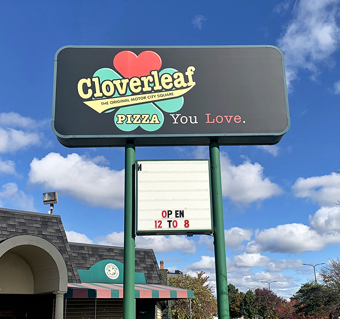 The Cloverleaf sign stands as a beacon of pizza perfection against Michigan skies, promising the authentic Detroit-style experience that pizza pilgrims seek.