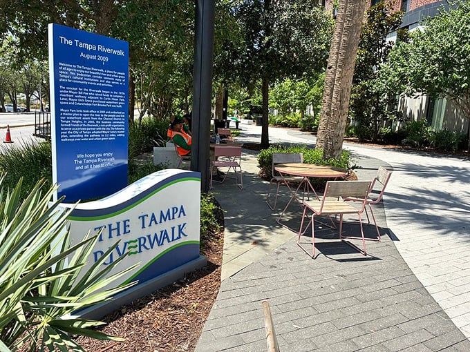 The official Tampa Riverwalk signage welcomes visitors to this urban oasis, with comfortable seating nearby for those ready to begin exploring.
