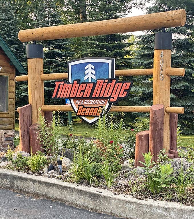 The Timber Ridge sign stands proud among the pines, marking the entrance to a place where every season brings its own brand of outdoor magic.