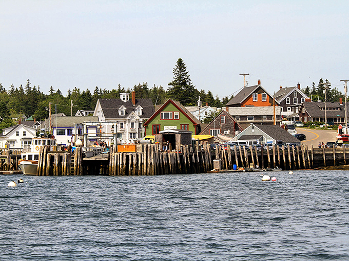 Port Clyde's lakeside homes enjoy front-row seats to nature's beauty, with colorful trees framing the peaceful waters.