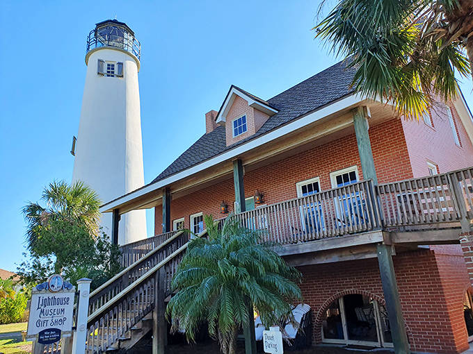 A closer view of Cape St. George Light reveals the detailed architecture of the keeper's house and museum. The wooden walkway invites visitors to explore this historical treasure.