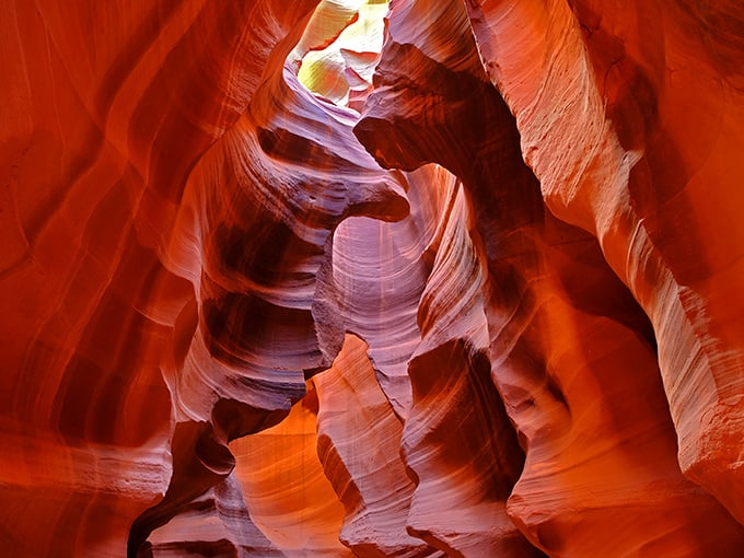 Sunlight dances through Antelope Canyon's narrow openings, painting the sandstone walls with a warm, otherworldly glow that seems almost liquid.