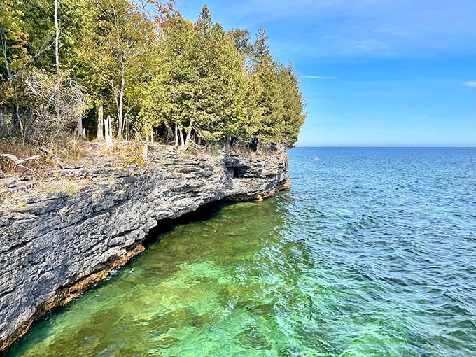 Turquoise waters meet dramatic limestone cliffs at Cave Point, creating Wisconsin's answer to the Caribbean coastline.