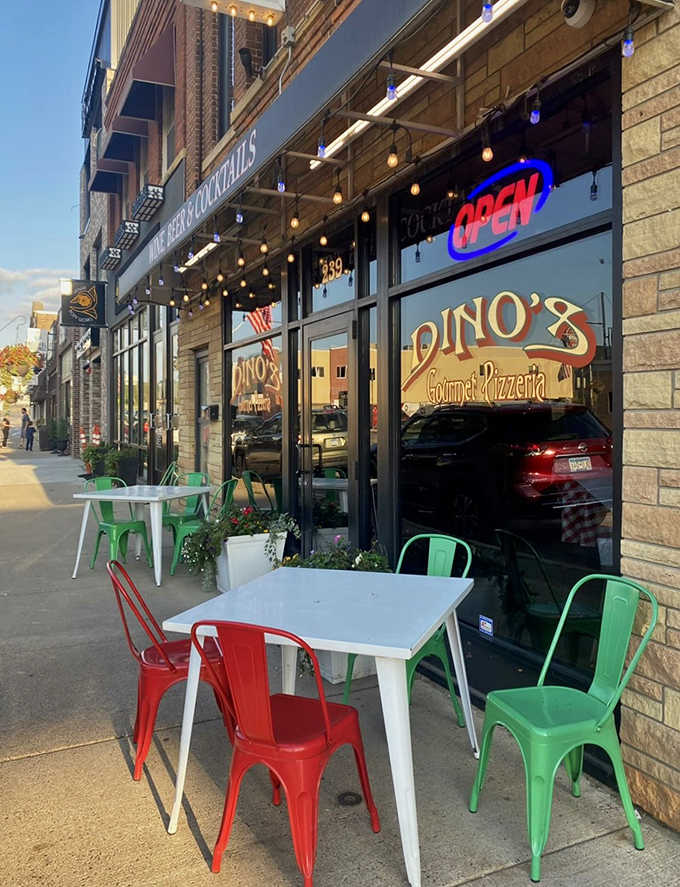 Dino's welcoming storefront with colorful red and green chairs invites pizza lovers to sit and stay awhile on Belgrade Avenue.