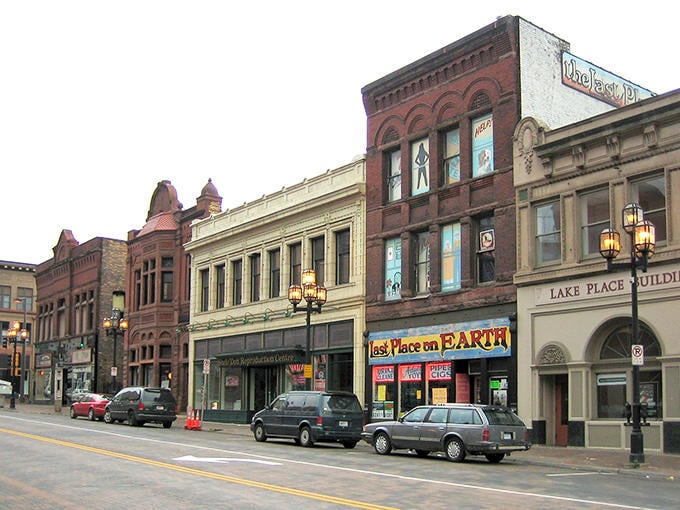 Historic brick buildings line Superior Street in downtown Duluth, showcasing the city's rich architectural heritage against a backdrop of urban charm.