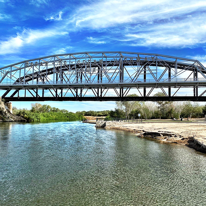 Gateway Park's sandy shores nestle beneath the historic Ocean-to-Ocean Bridge, creating a perfect riverside beach day in Yuma.