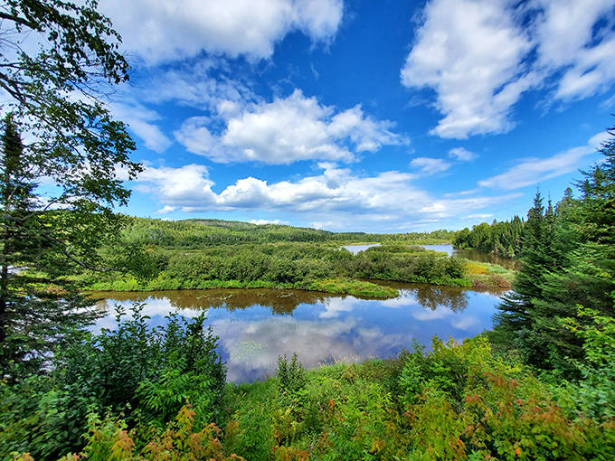 The breathtaking High Falls at Grand Portage State Park mirrors the sky in its crystal waters, creating a double dose of Minnesota blue.
