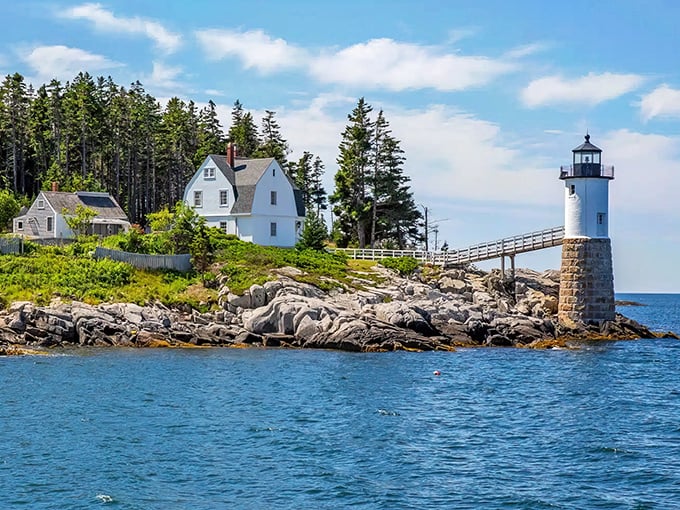 Isle au Haut's iconic lighthouse stands sentinel on rocky shores, a postcard-perfect scene that captures Maine's maritime soul.
