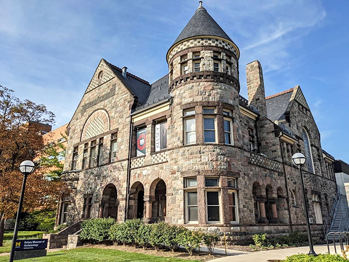 The Kelsey Museum's stone facade stands proudly on Ann Arbor's State Street, its castle-like tower reaching skyward like a medieval sentinel among university buildings.
