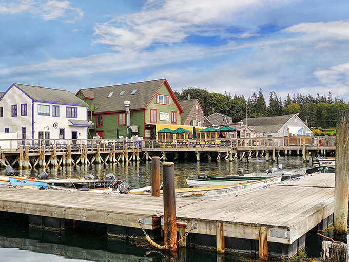 Norway's colorful waterfront buildings create a postcard-perfect scene, with wooden docks extending into the calm harbor waters.