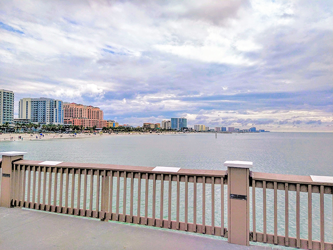 Clearwater Beach's Pier 60 stretches into the Gulf like a welcome mat to paradise, where colorful buildings line the shore under Florida's famous blue skies.