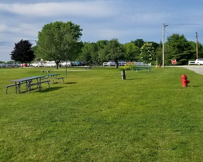 Poland's community park offers a peaceful retreat with picnic tables and green spaces perfect for family gatherings on sunny Maine afternoons.