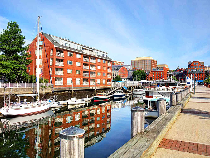 Portland's waterfront gleams in the morning light, brick buildings reflecting in calm harbor waters where boats await their next adventure.