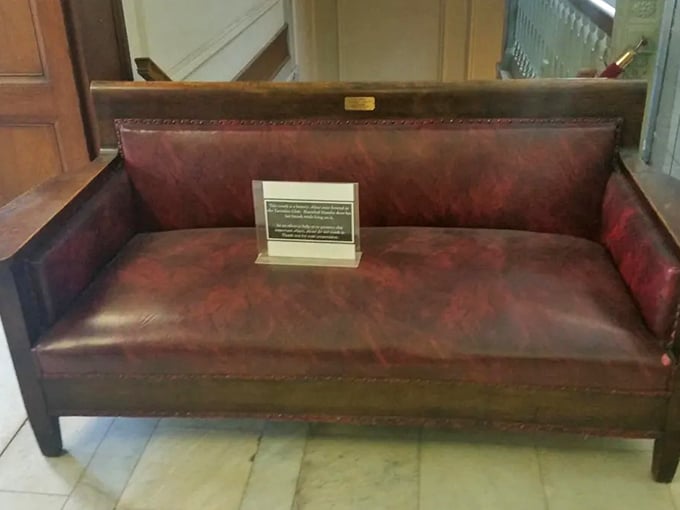 The infamous Hannibal Hamlin Death Couch sits solemnly in Bangor Public Library, its worn leather holding the last moments of Lincoln's first VP.