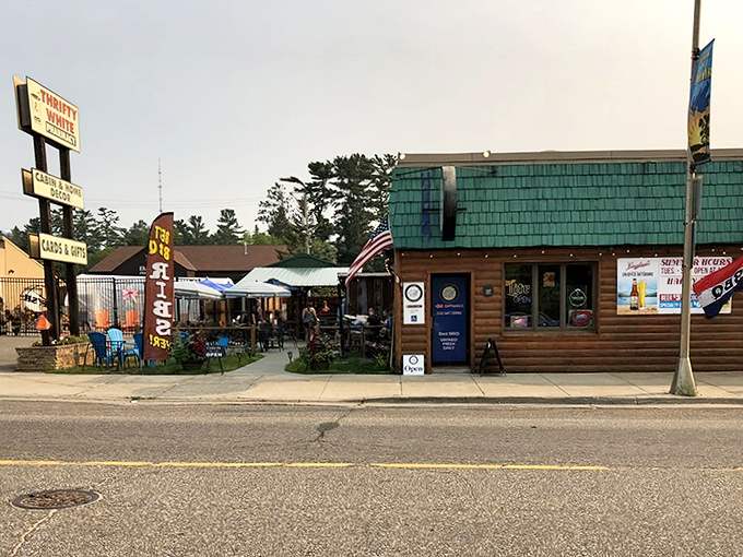 The Piggy BBQ's rustic log cabin exterior invites BBQ lovers with its charming green-shingled roof and wooden walls &ndash; a true northwoods treasure hiding smoky delights inside.