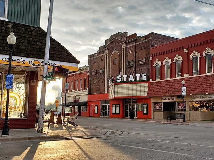 The historic State Theatre stands as Alpena's entertainment anchor, its classic marquee glowing against the evening sky.