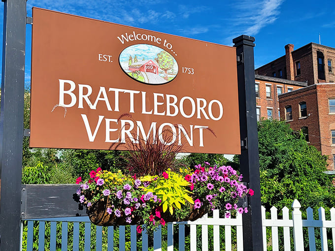 The welcome sign says it all: Brattleboro has been charming visitors since 1753, and those colorful flowers prove they're still putting in the effort.