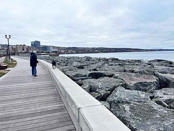 Canal Park's lakewalk offers stunning views of Lake Superior's vastness, with the city skyline creating a perfect backdrop.