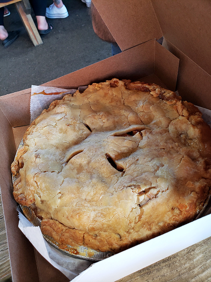 Golden-crusted apple pie from Crane's, where generations of Michigan apple-growing expertise meets flaky, buttery pastry perfection.