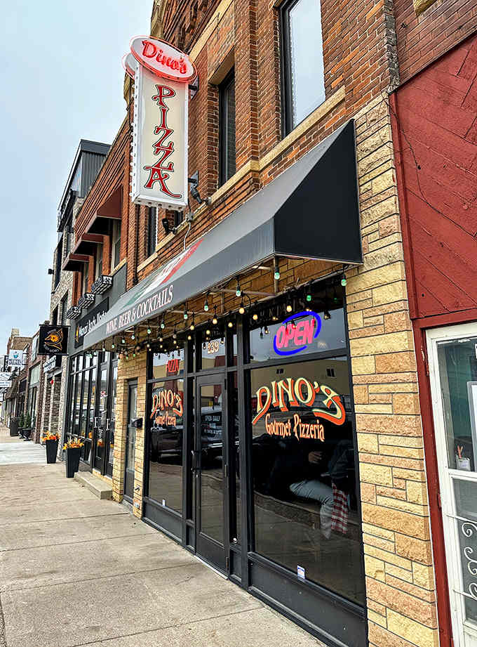 The classic neon sign and brick exterior of Dino's Pizzeria promises authentic gourmet pizza experiences in the heart of North Mankato.