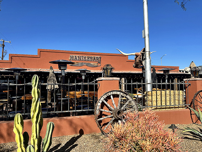 The Western-themed exterior of Handlebar J stands proudly against the Arizona sky, complete with desert landscaping and authentic ranch touches.