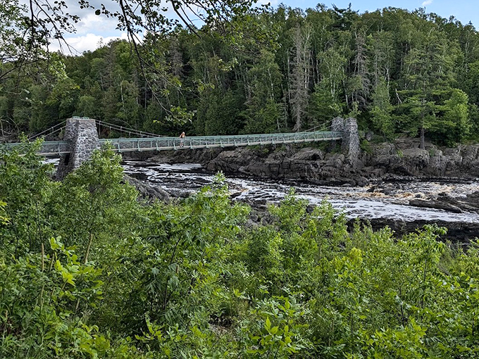 Jay Cooke's suspension bridge offers stunning views of the river gorge, where ancient rock formations create natural rapids that mesmerize visitors year-round.