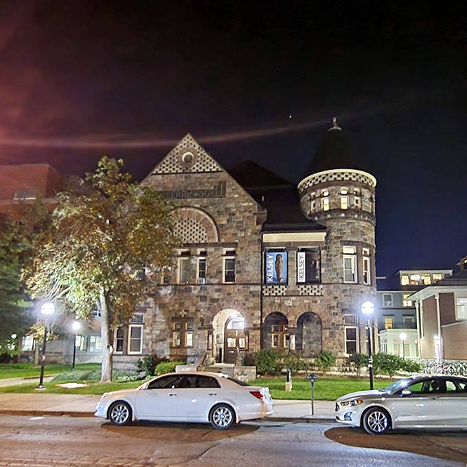 As night falls, the Kelsey's stone walls glow with warmth, transforming this academic treasure house into a magical castle straight from a storybook.