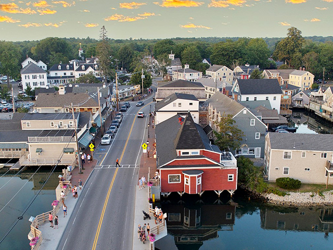 A bird's-eye view of Kennebunkport reveals its perfect coastal layout, with the distinctive red building on stilts creating a focal point where land meets sea.