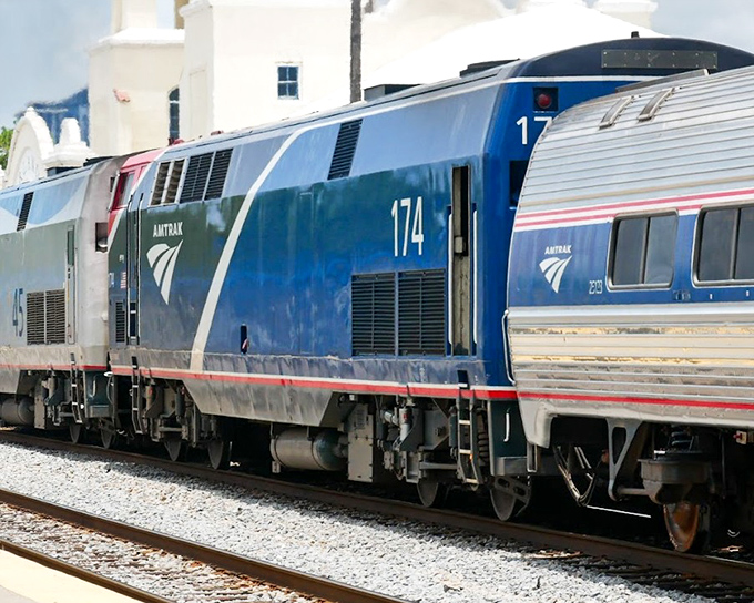 Amtrak's powerful locomotive #174 stands ready at the platform, its distinctive red, white and blue livery promising journeys to charming small towns just waiting to be explored.