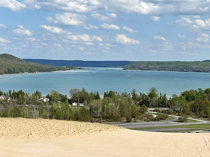 A breathtaking panorama of Glen Lake from the dunes, where sandy slopes meet crystal waters. The perfect reward after a heart-pumping climb to the viewpoint.