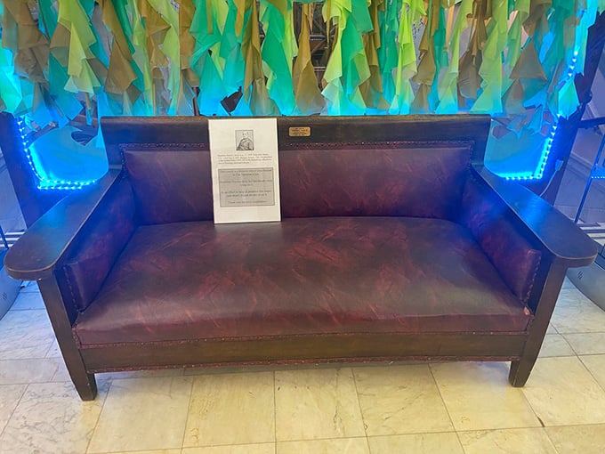 Decorated with colorful streamers, the historic death couch creates an oddly festive backdrop for one of America's most unusual historical artifacts.